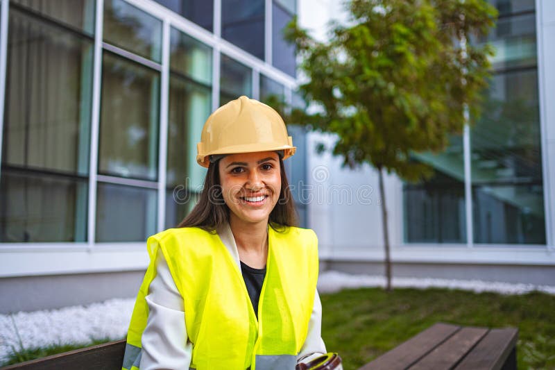 Smiling Female Safety Engineer Sitting on a Bench Stock Photo - Image ...