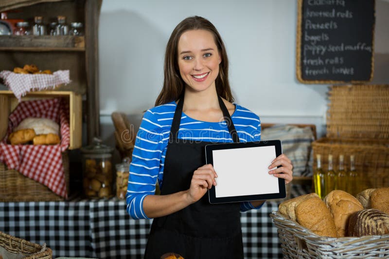 Smiling Female Staff Using Digital Tablet at Counter Stock Photo ...