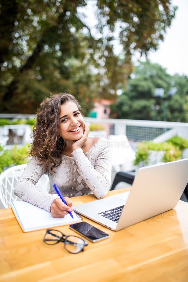 Smiling Latin Female Student Doing Homework by Laptop at Cafeteria ...