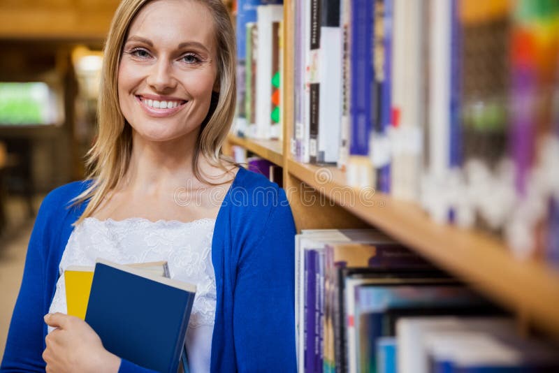 Smiling Female Student Holding a Book Stock Image - Image of school ...