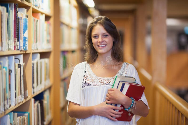 Smiling Female Student Standing in the Library Stock Image - Image of ...
