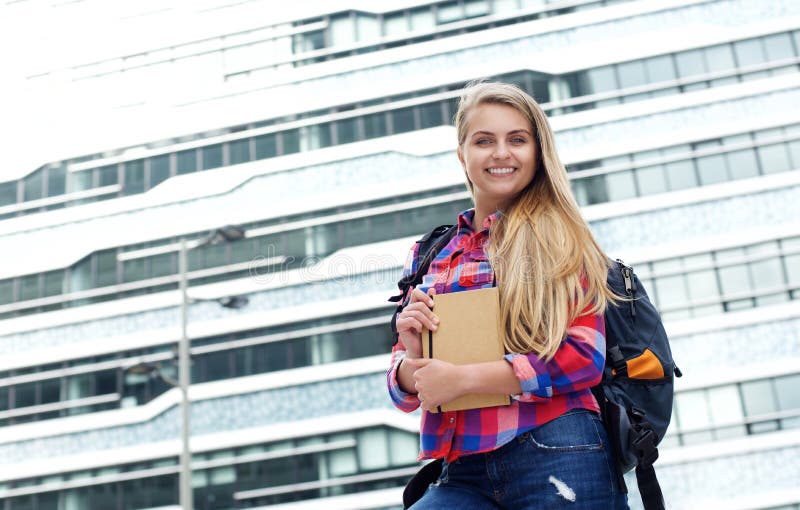 Smiling Female Student Standing Outside with Bag and Book Stock Photo ...