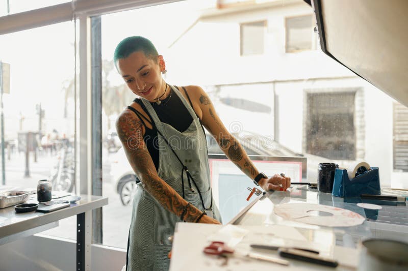 Smiling Female Worker Preparing Screen Printing Film while Using ...