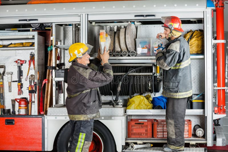 Smiling Firefighters Working at Truck Stock Image - Image of quality ...