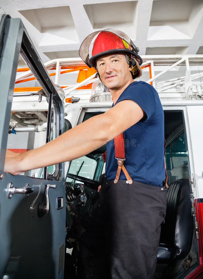 Smiling Fireman Standing on Truck Stock Photo - Image of people ...