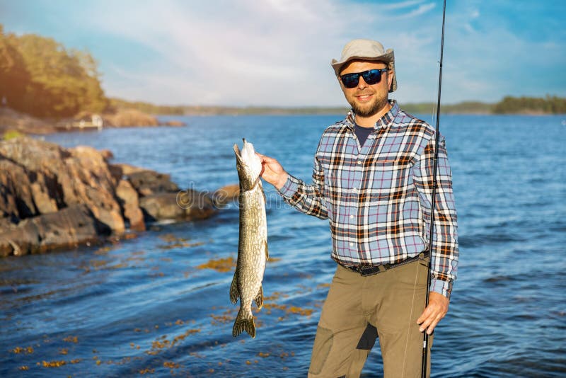 Smiling Fisherman with Caught Pike Fish in Hand Stock Photo - Image of ...