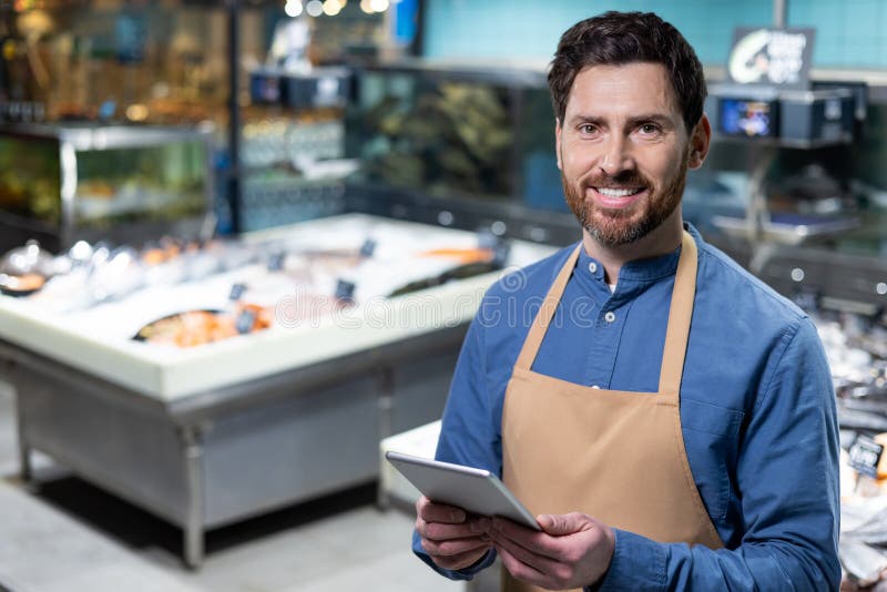 Smiling Fishmonger Holding Tablet in Modern Seafood Market Stock Image ... Smiling Fishmonger Holding Tablet in Modern Seafood Market Stock Image ...
