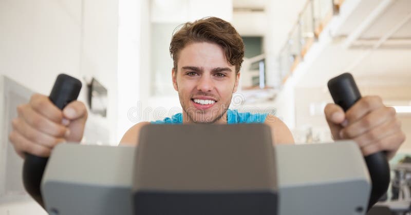 Smiling Fit Man on the Exercise Bike Stock Photo - Image of front ...
