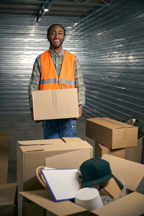 Joyous Loader Posing for Camera Unloading Goods in Storage Unit Stock ...