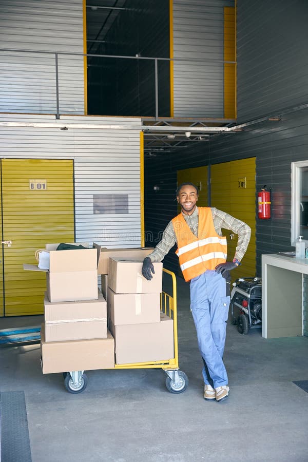 Smiling Freight Handler Posing for Camera in Workplace Stock Photo ...