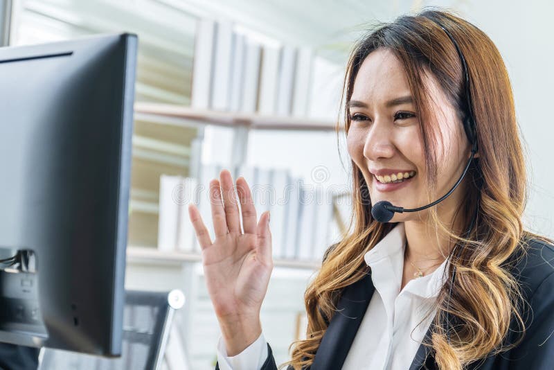 Smiling Friendly Asian Businesswoman with Headset Working and Greets ...