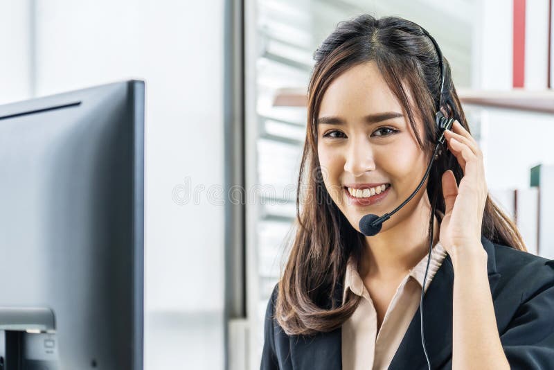 Asian Female Worker in Safety Vest Sitting and Working with Computer ...