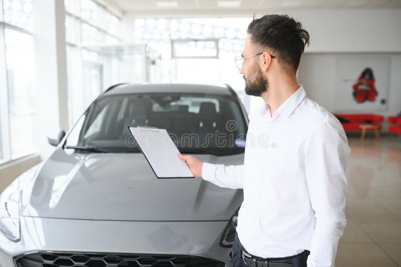 Smiling, Friendly Car Seller Standing in Car Salon. Stock Image - Image ...