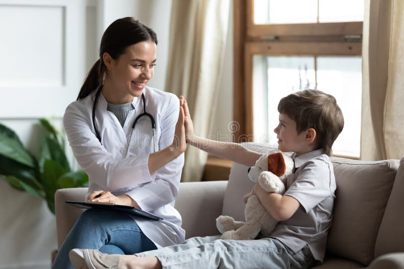Smiling Friendly Doctor and Preschool Patient Giving High Five Stock ...