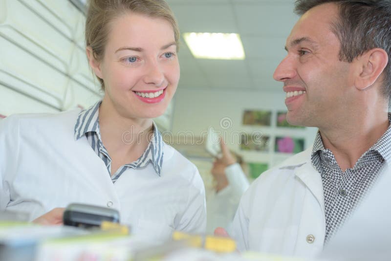 Smiling Friendly Efficient Male and Female Pharmacists Stock Image ...