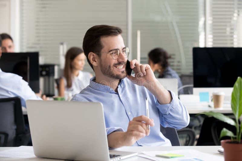 Smiling Friendly Man Talking on Phone in Office Stock Photo - Image of ...