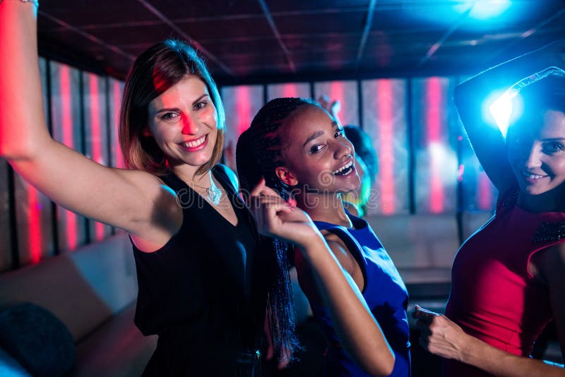 Smiling Friends Dancing on Dance Floor Stock Photo - Image of ...