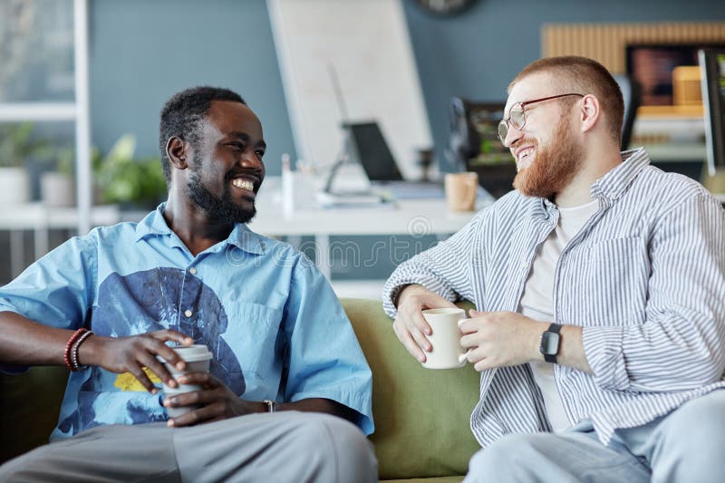 Smiling Friends Having Coffee in Bright Office Setting Stock Image ...