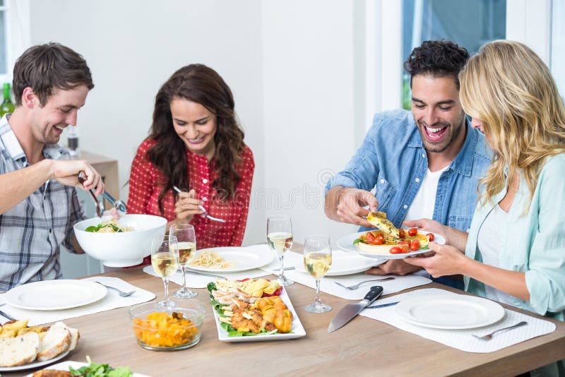 Smiling Friends Having Food Stock Photo - Image of four, holding: 68234234