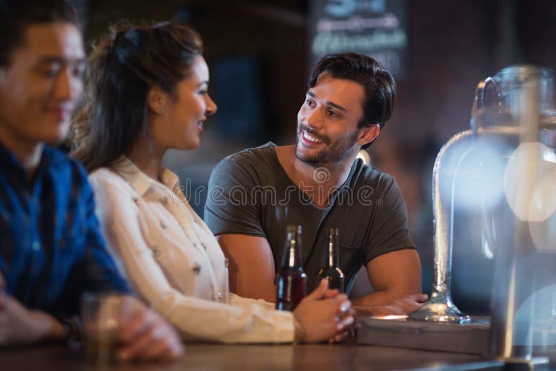 Smiling Friends Interacting at Bar Counter Stock Image - Image of adult ...