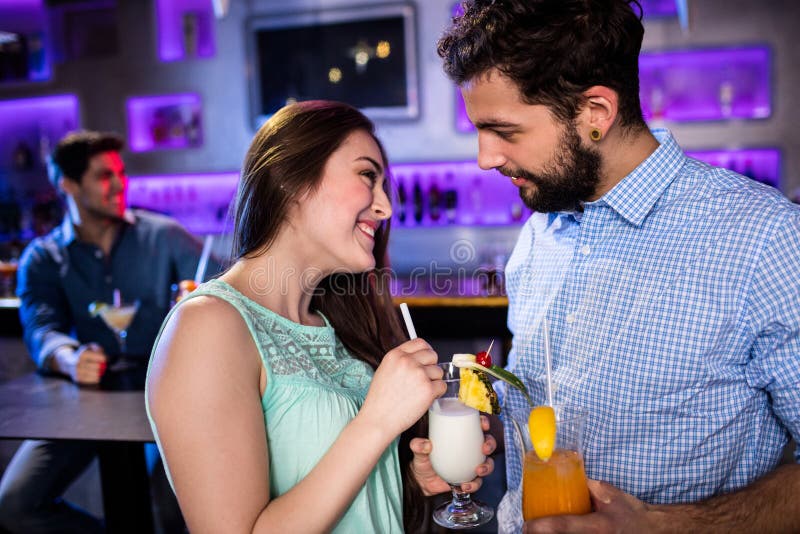 Smiling Friends Interacting with Each Other at Bar Counter while Having ...