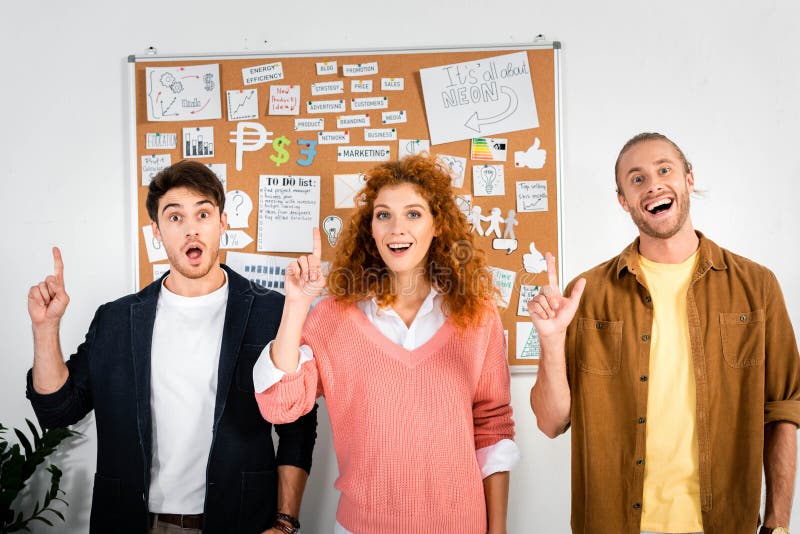 Smiling Friends Showing Idea Gestures and Looking at Camera Stock Image ...