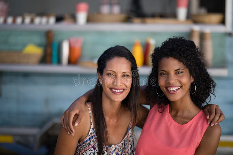 Smiling Friends Sitting with Arm Around Stock Photo - Image of modern ...
