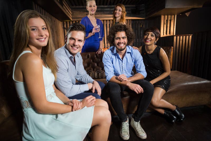 Smiling Friends Sitting Together in Sofa Stock Image - Image of indoors ...