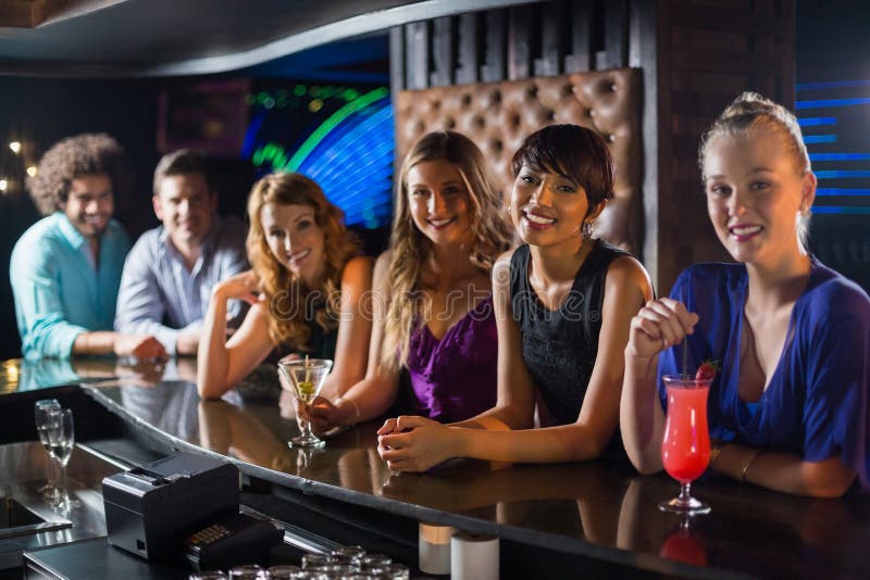 Smiling Friends Standing Together at Bar Counter Stock Photo - Image of ...