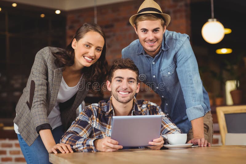 Smiling Friends Using Tablet Computer Stock Photo - Image of americano ...