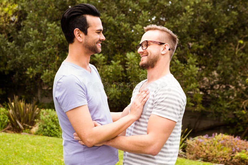 Smiling gay couple hugging stock image. Image of embracing - 66094781