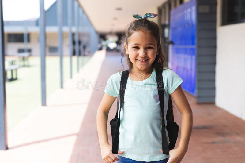 Smiling Girl with Backpack Standing in School Hallway, Ready for Class ...