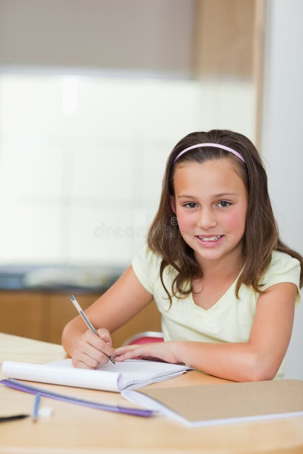 Smiling Girl Doing Homework Stock Photo - Image of table, education ...