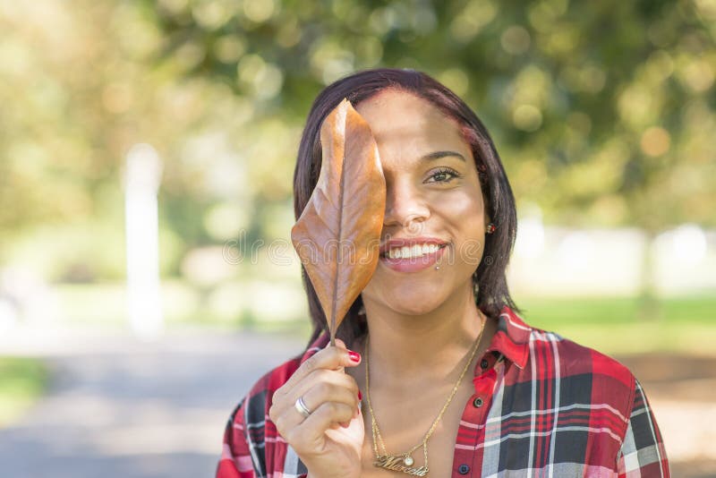 Smiling Girl Face is Covered with Old Tree Leaf, Outdoor. Stock Photo ...