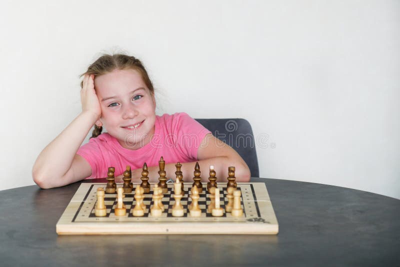 Smiling Girl in Front of Chess Set Out for Play Stock Image - Image of ...