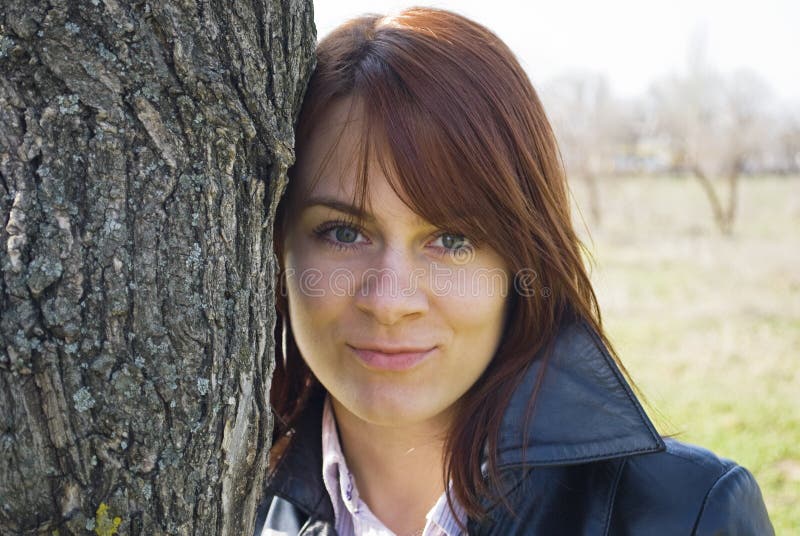 Smiling girl near the tree stock photo. Image of attractive - 13805056