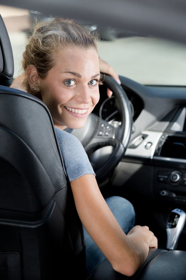Smiling Girl Sitting in Car and Looking Back Stock Photo - Image of ...