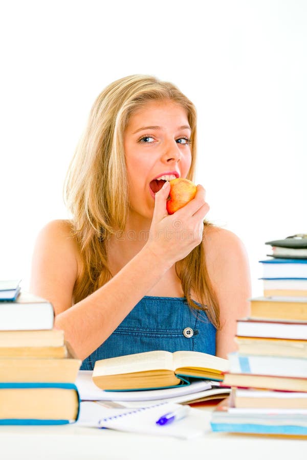 Smiling Girl Sitting at Table and Eating Apple Stock Image - Image of ...