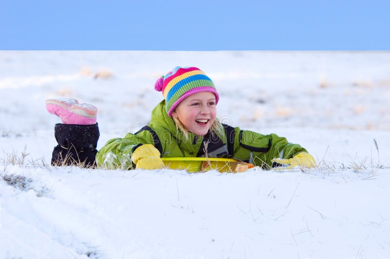 Girl sledding down a hill stock image. Image of sled - 42977865