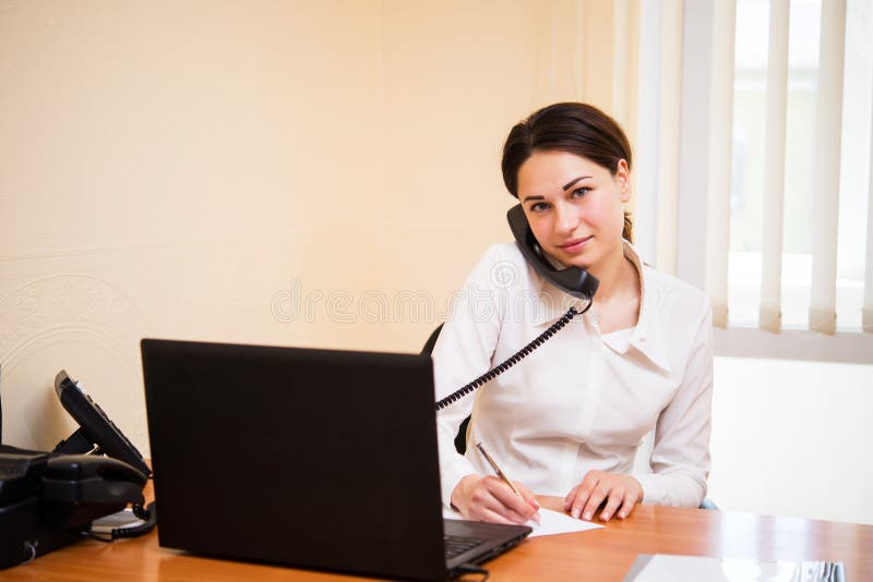 Smiling Girl Speaks by Telephone in the Office Stock Image - Image of ...