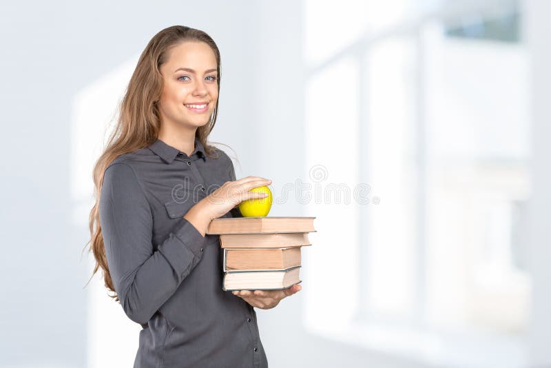 Smiling Girl with Stacked Books Stock Image - Image of facial ...