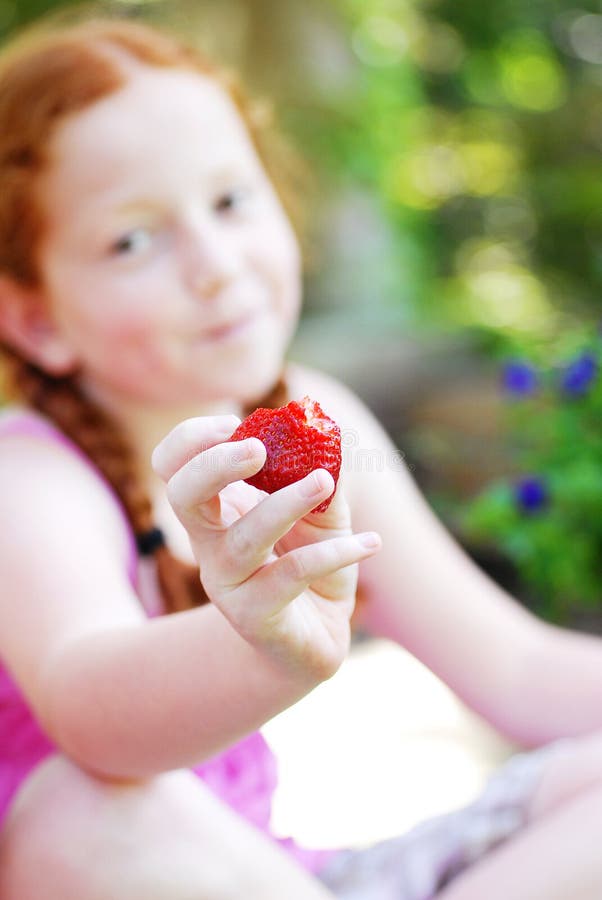 Smiling Girl with Strawberry Stock Photo - Image of holding, girl: 15178308