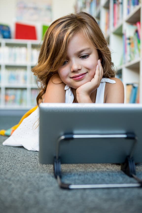 Smiling Girl Using Digital Tablet in School Library Stock Image - Image ...