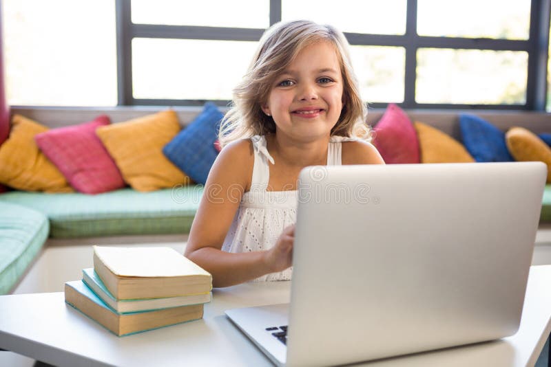 Smiling Girl Using Laptop in School Library Stock Photo - Image of ...