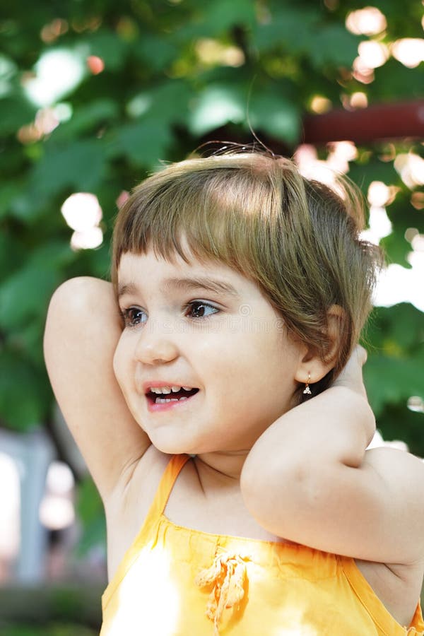 Smiling girl in yellow stock photo. Image of outdoors - 10081916