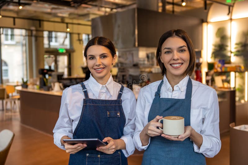 Smiling Girls in Apron Standing in the Coffee Shop Stock Photo - Image ...