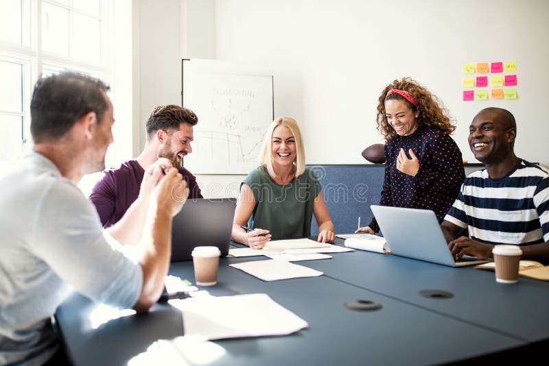 Smiling Group of Designers Working Together in an Office Stock Image ... Smiling Group of Designers Working Together in an Office Stock Image ...