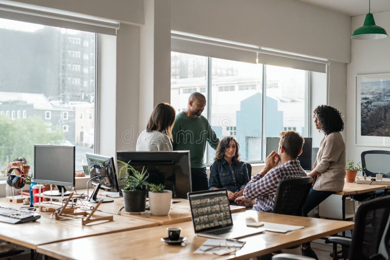 Smiling Group of Diverse Designers Meeting Together in Their Office ... Smiling Group of Diverse Designers Meeting Together in Their Office ...