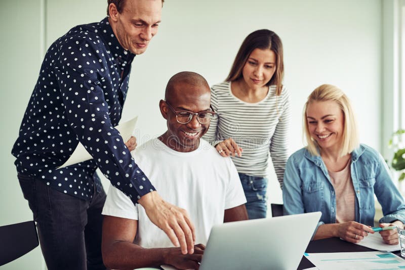 Smiling Group of Diverse Work Colleagues Working with a Laptop Stock ... Smiling Group of Diverse Work Colleagues Working with a Laptop Stock ...