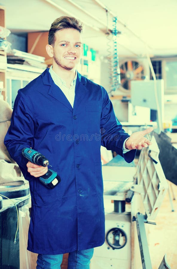 Smiling Guy Carpenter Working with Professional Drill Stock Photo ...